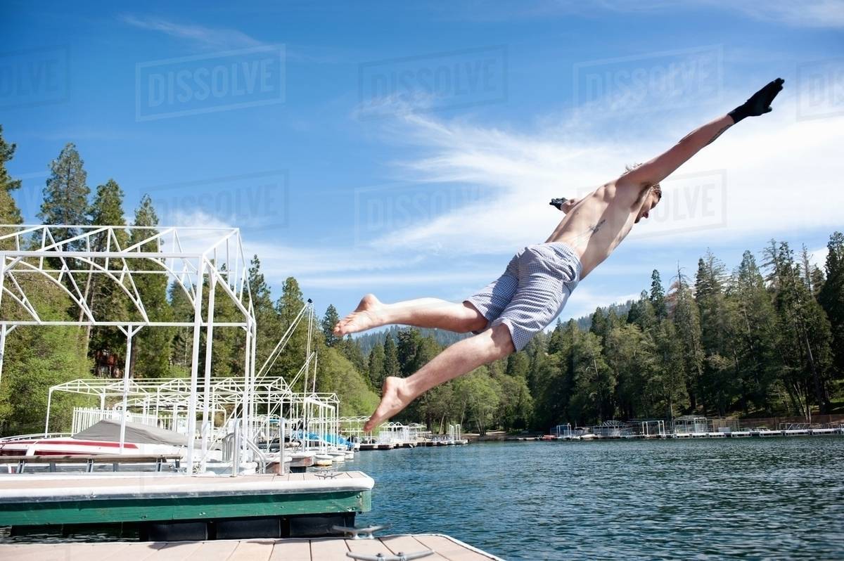 Man diving off jetty - Royalty-free Stock Photo | Dissolve