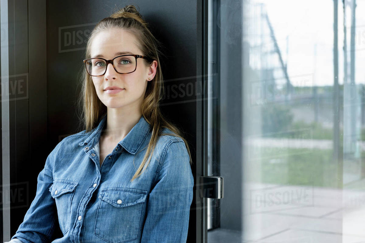 Portrait of young blond businesswoman wearing glasses. - Stock Photo ...