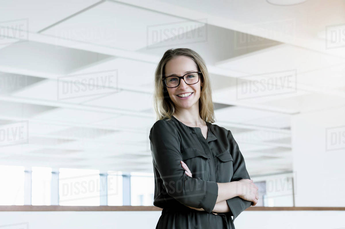 Portrait of young blond businesswoman wearing glasses. - Stock Photo ...