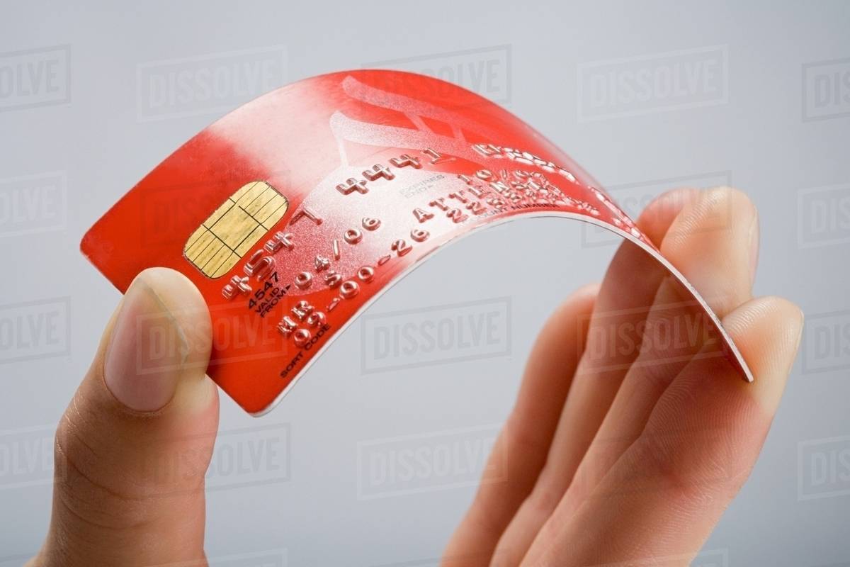 A person holding a credit card - Royalty-free Stock Photo | Dissolve