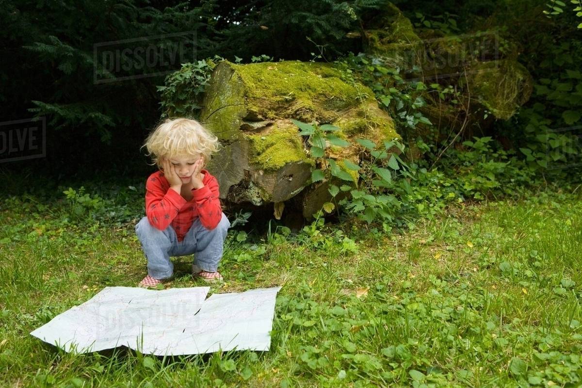 A boy with a map - Stock Photo - Dissolve