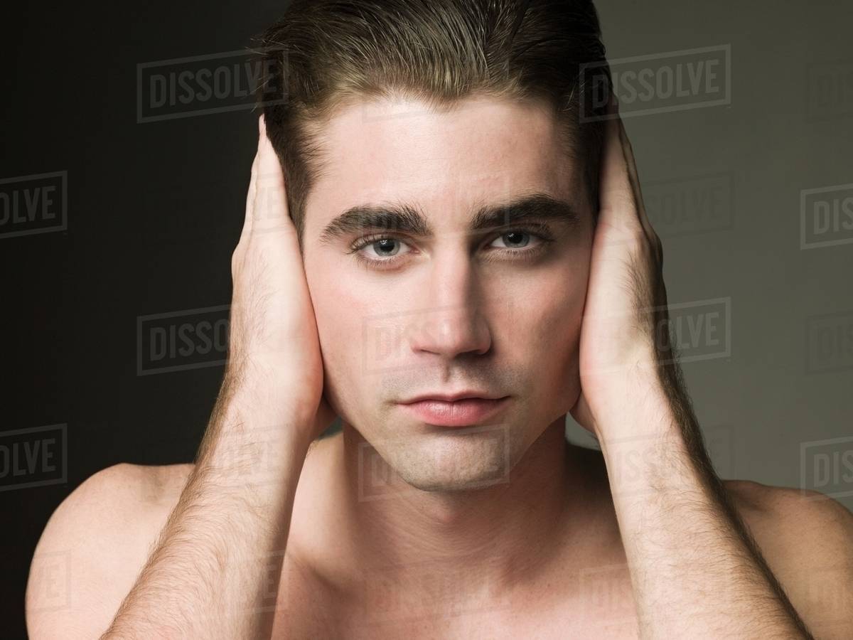 Man with hands over ears - Royalty-free Stock Photo | Dissolve