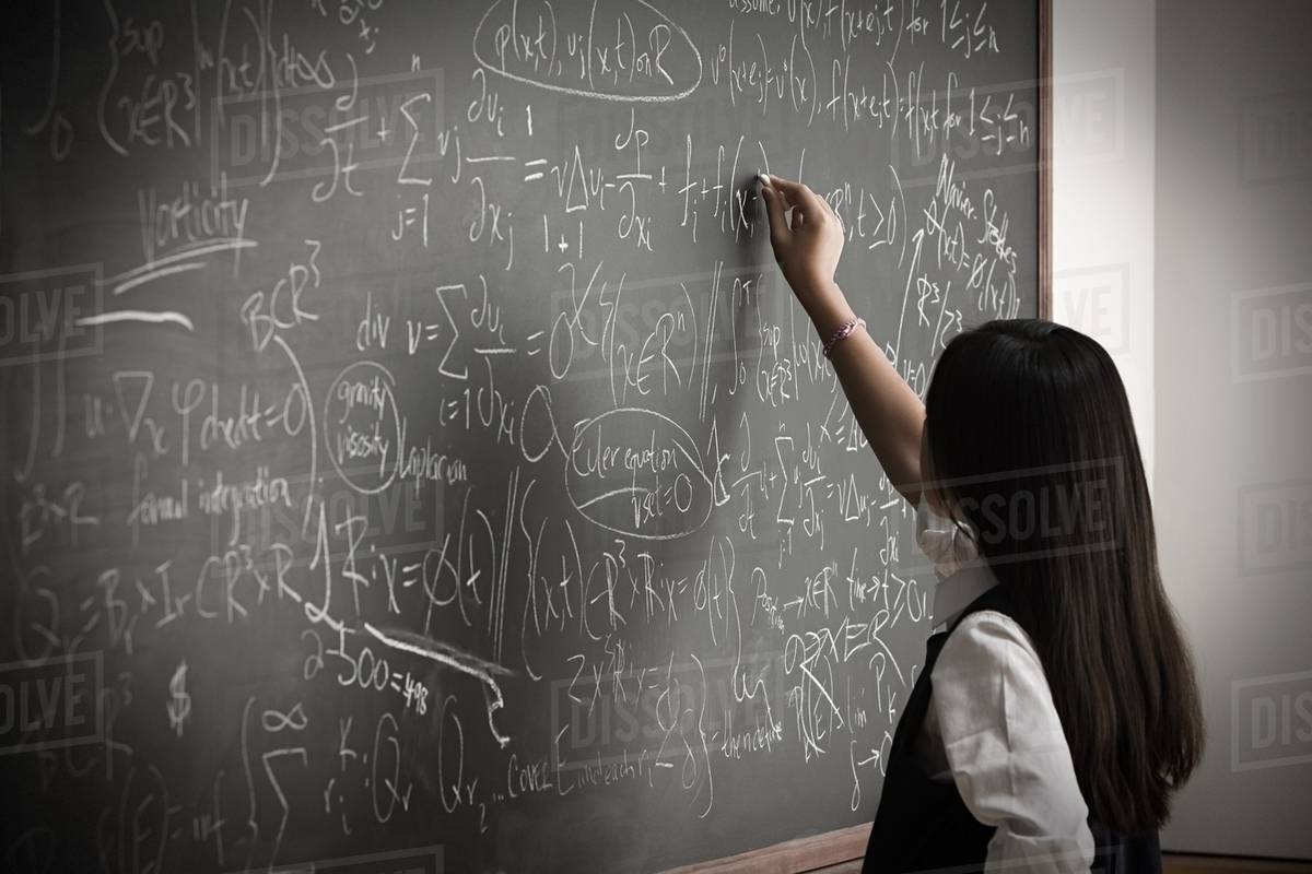 Girl writing on blackboard - Royalty-free Stock Photo | Dissolve
