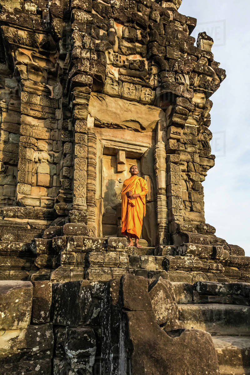 Monk, Bakong Temple ruins (part of the Roluos Group of pre-Angkorian ...