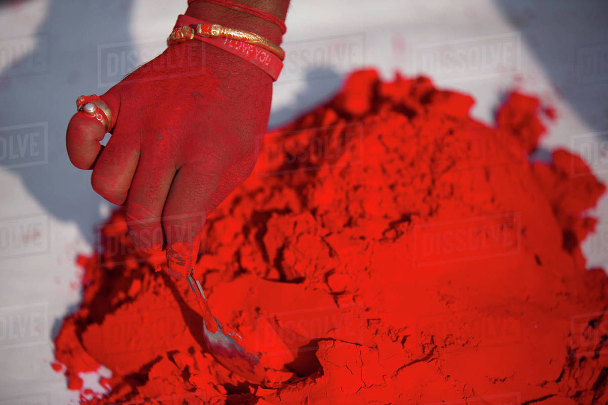 Close up of hand mixing red powder, Jaipur, Rajasthan, India - Royalty ...