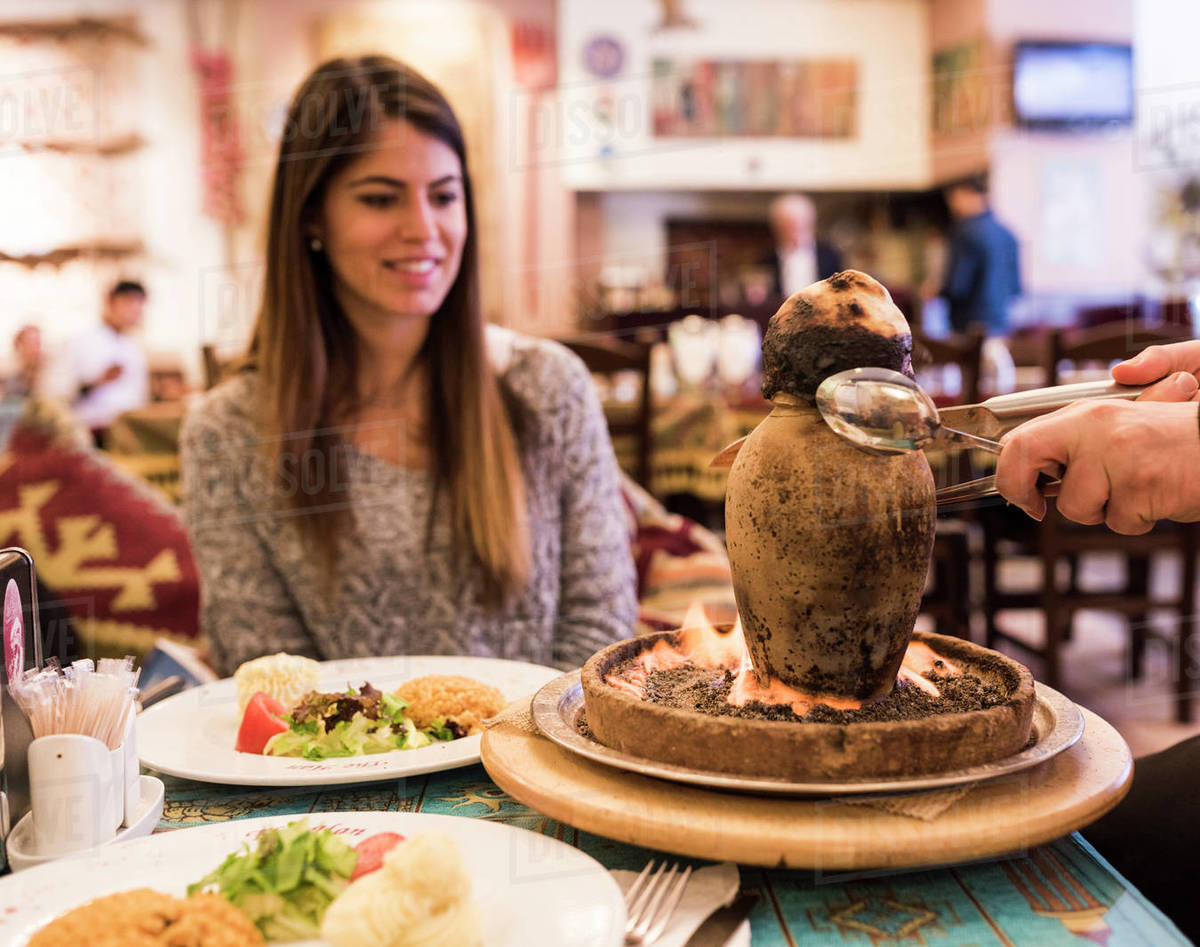 Young woman being served food in restaurant, Istanbul, Turkey - Royalty ...
