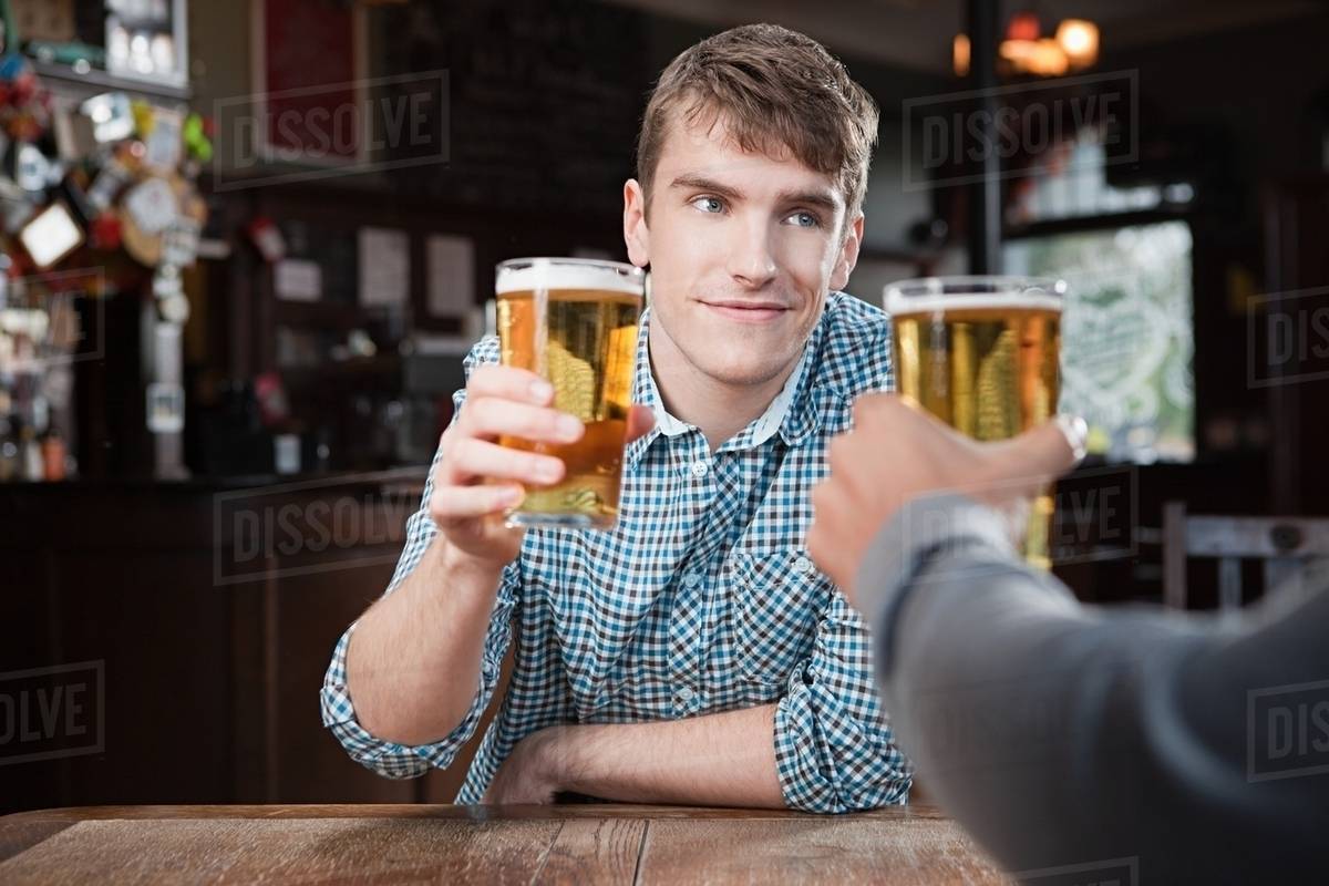 Young men in bar - Royalty-free Stock Photo | Dissolve