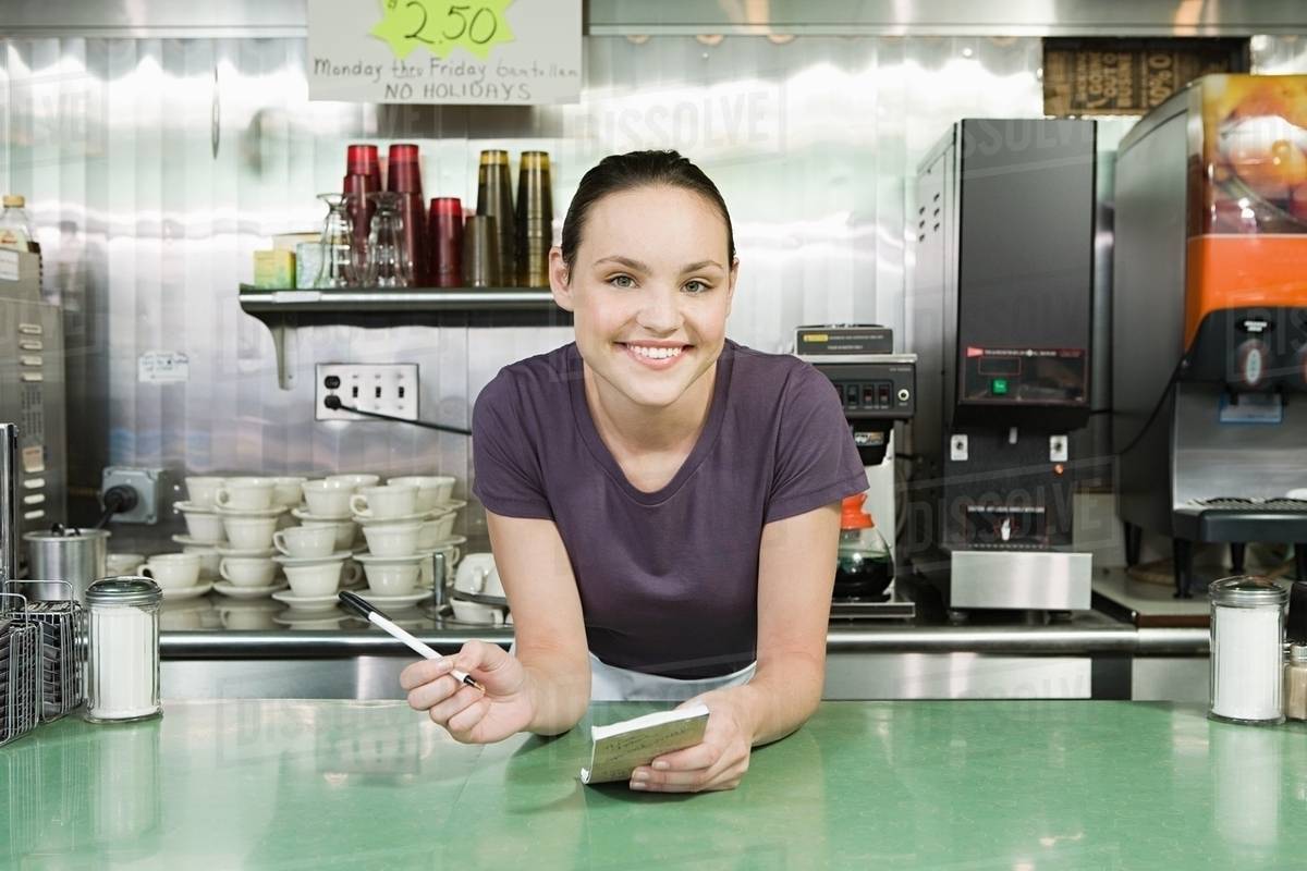 Smiling waitress in a diner - Royalty-free Stock Photo | Dissolve