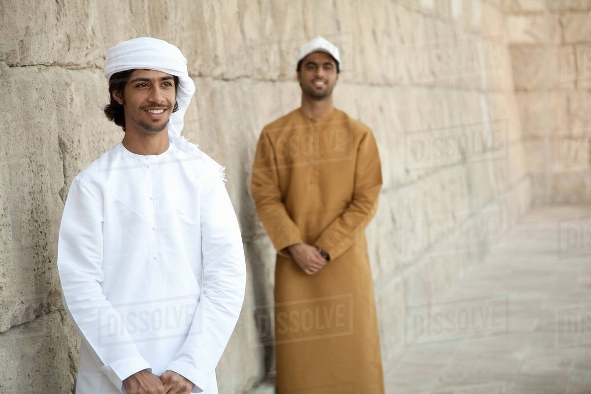 Middle Eastern men looking at by stone wall - Royalty-free Stock Photo ...