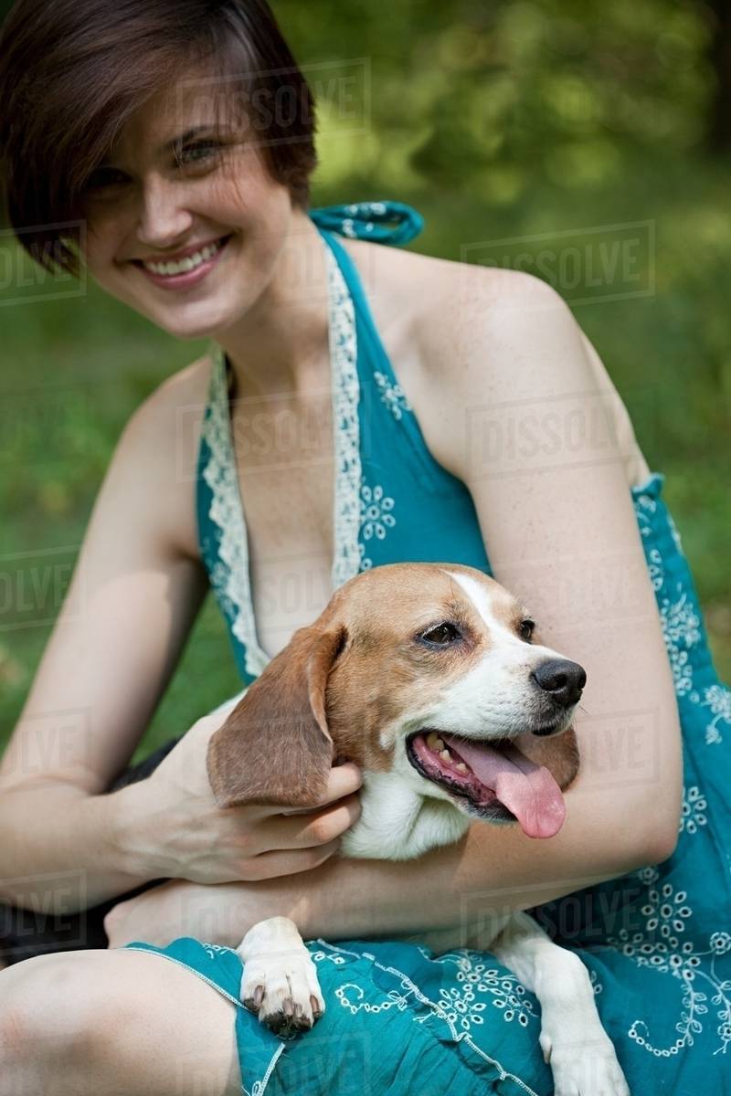 Woman holding her pet beagle - Royalty-free Stock Photo | Dissolve