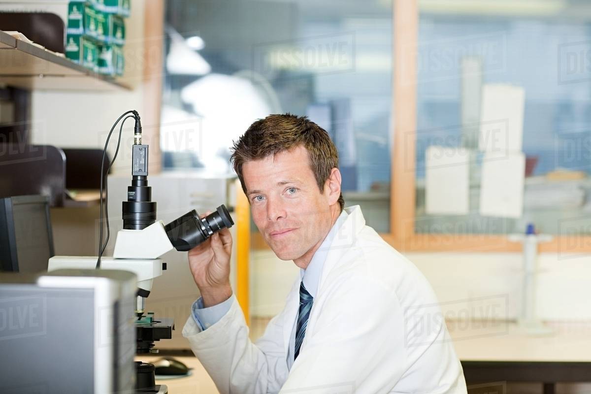 Doctor with microscope - Stock Photo - Dissolve