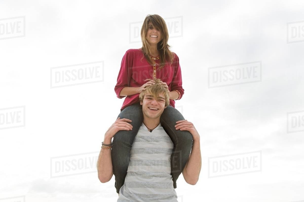 Young couple, man carrying girl on shoulders - Royalty-free Stock Photo ...