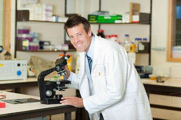 Doctor with microscope - Stock Photo - Dissolve