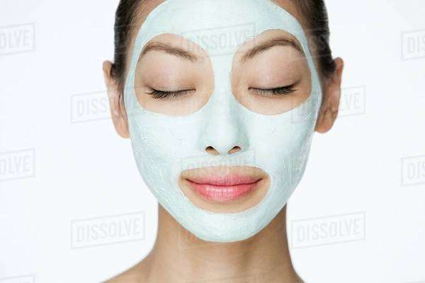 Young woman wearing face mask - Stock Photo - Dissolve