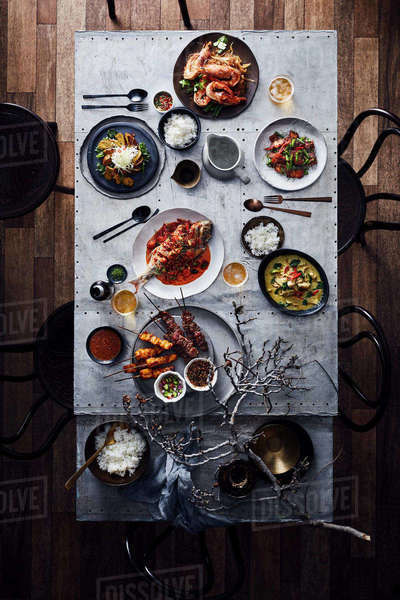 Table with authentic Thai menu dishes - Royalty-free Stock Photo | Dissolve