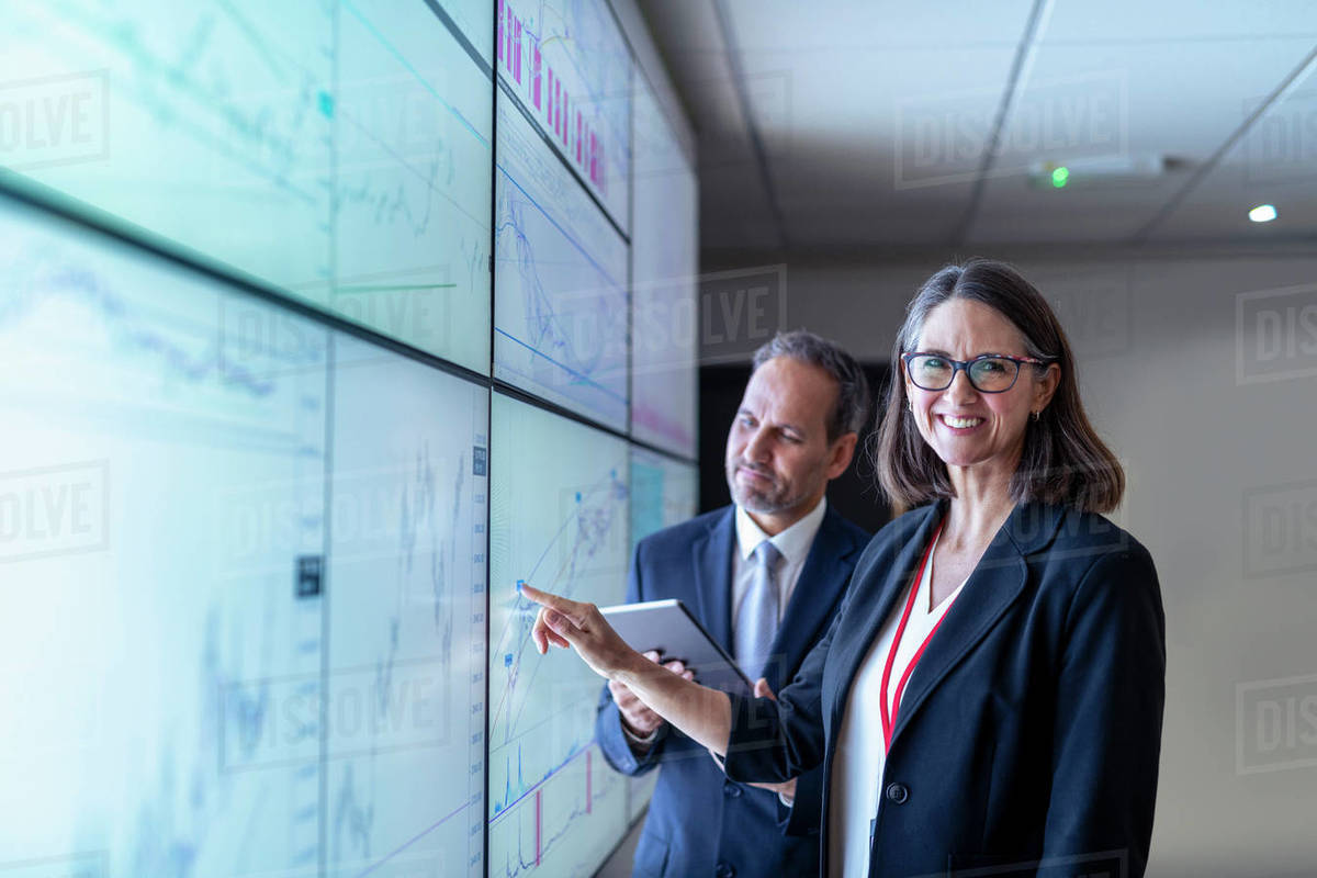 Business people working with charts on interactive screens - Stock ...