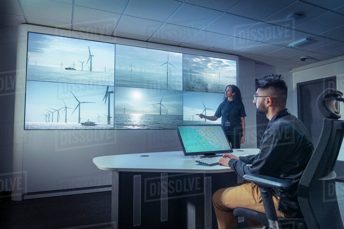 Male and female operators in offshore wind farm control room - Royalty ...