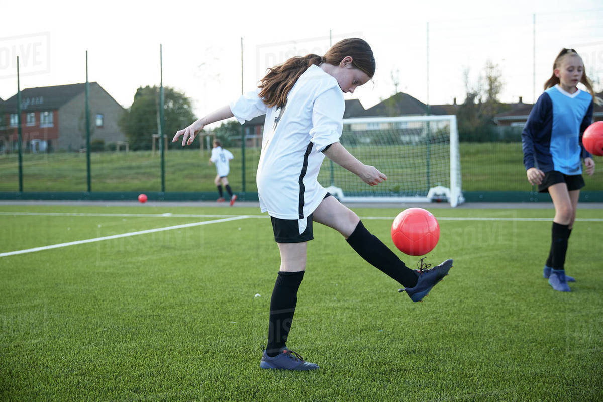 Girls' soccer team having training in field - Stock Photo - Dissolve