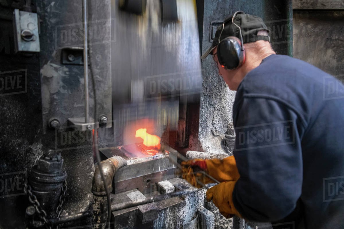 Engineer forging titanium parts in hammer press in industrial forge - Royalty-free Stock Photo ...