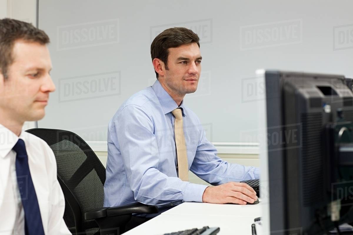 Businessmen using computers - Stock Photo - Dissolve