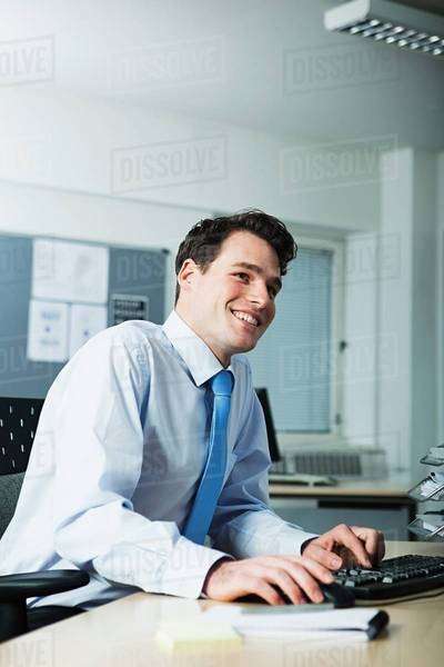Office worker using computer - Royalty-free Stock Photo | Dissolve
