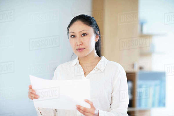 Portrait of businesswoman with documents in office - Royalty-free Stock ...