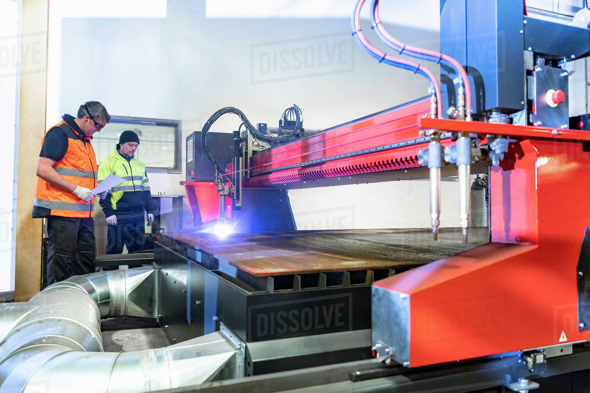 Engineers with plasma cutting machine in engineering factory - Stock ...