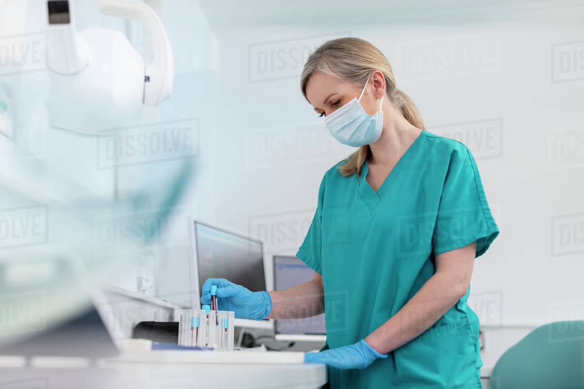 Dental nurse with blood samples for testing in dental surgery - Royalty ...