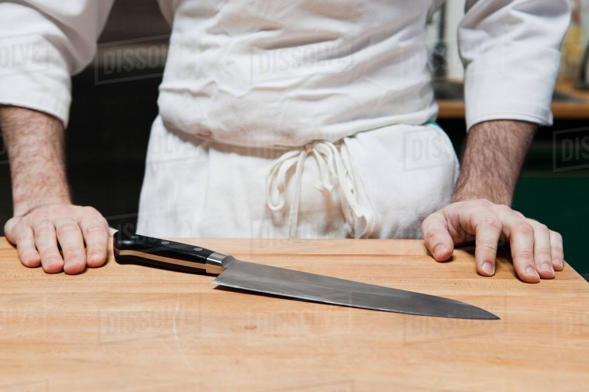 Close up of butcher with chopping board and knife - Stock Photo - Dissolve