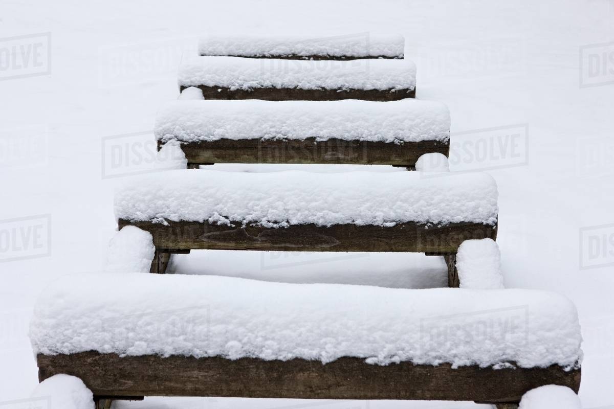 Wooden logs covered in snow - Royalty-free Stock Photo | Dissolve
