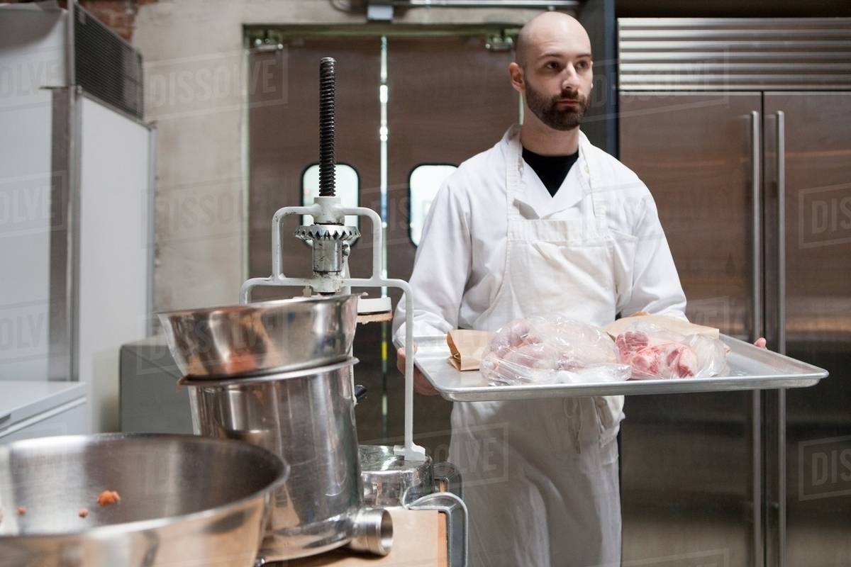 Butcher with tray of meat - Royalty-free Stock Photo | Dissolve