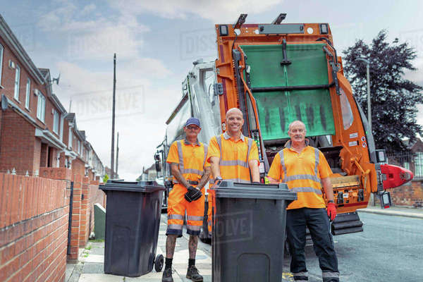 Portrait of refuse collectors with bins and refuse truck - Royalty-free ...