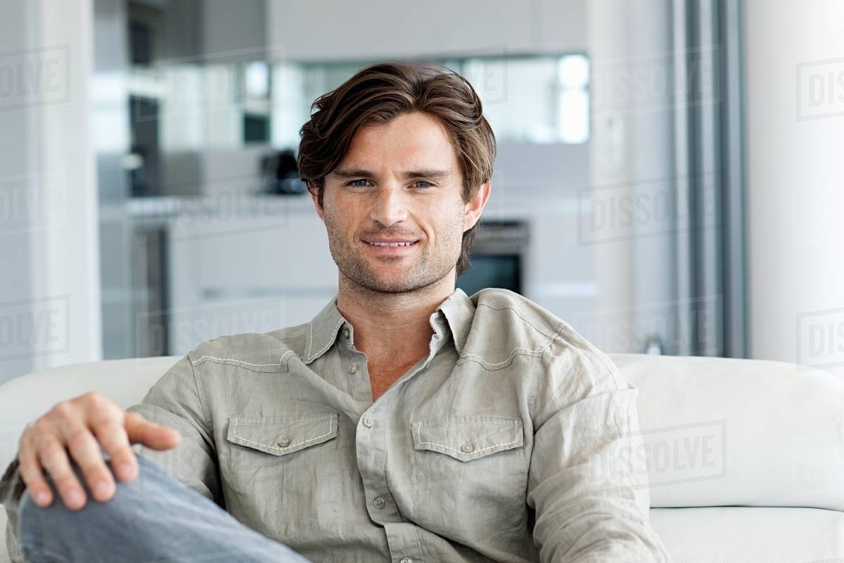 Man in living room, portrait - Royalty-free Stock Photo | Dissolve