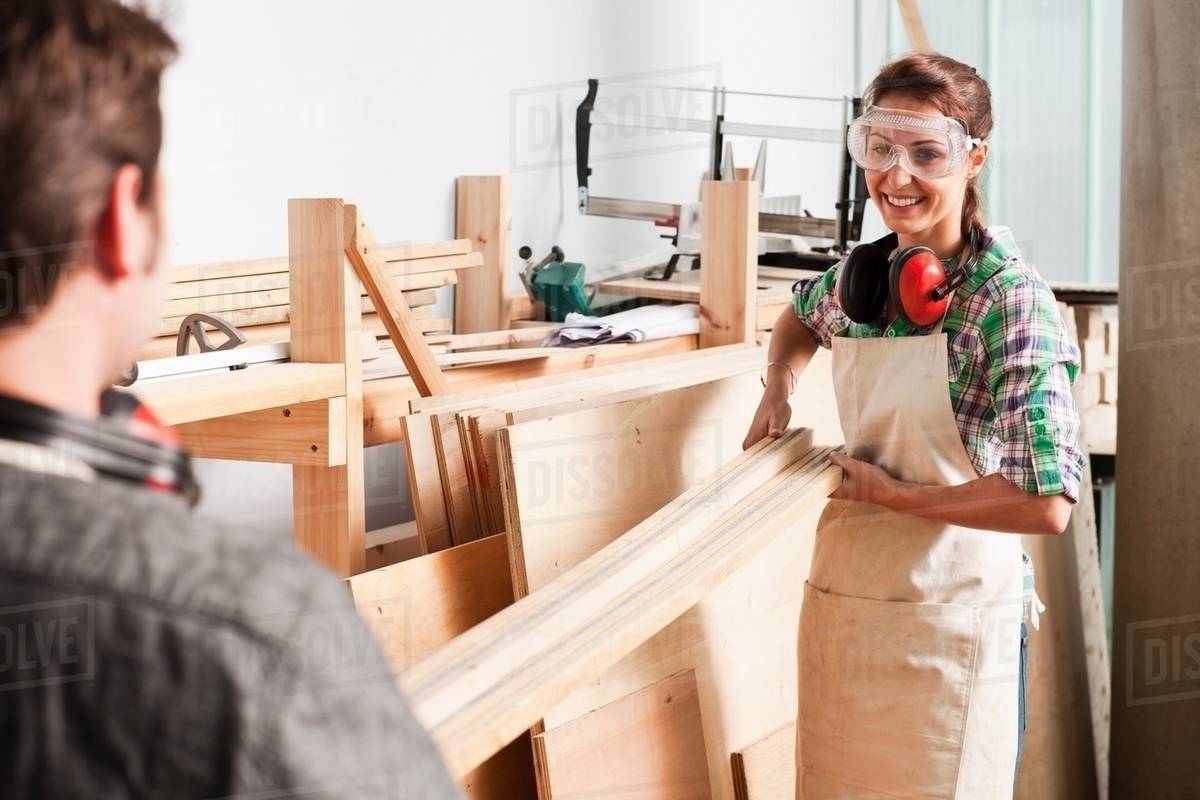 Carpenters carrying wood in workshop - Stock Photo - Dissolve