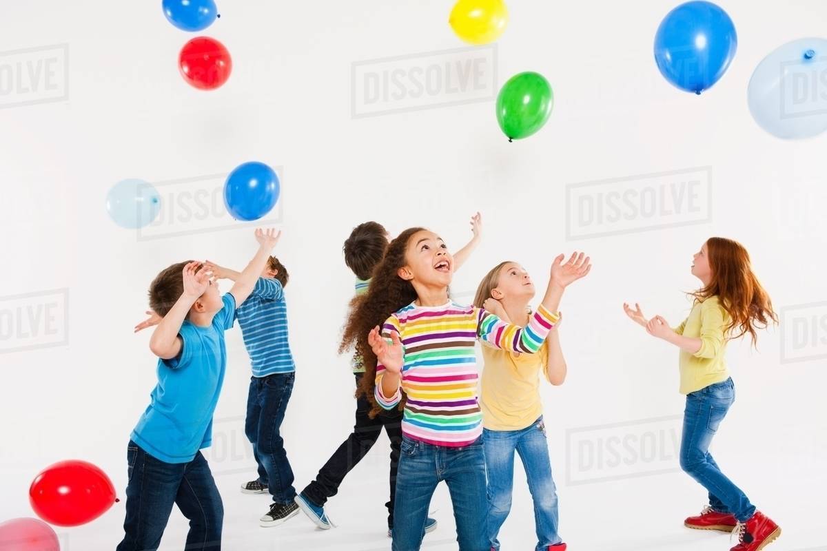 Children playing with balloons - Stock Photo - Dissolve