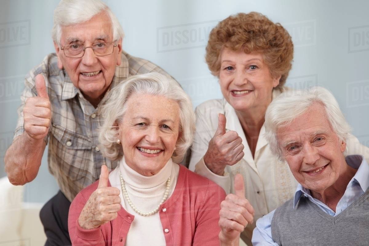 Four seniors with thumbs up, portrait - Royalty-free Stock Photo | Dissolve