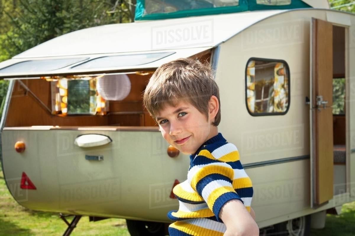 Boy outside caravan, portrait - Royalty-free Stock Photo | Dissolve