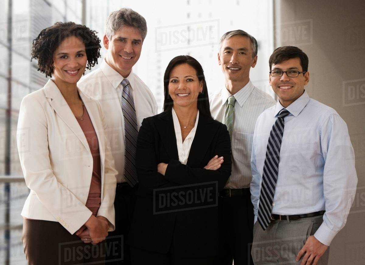 Business colleagues standing in office, portrait - Stock Photo - Dissolve