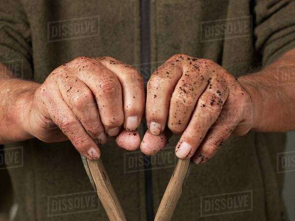 Man leaning with hands on wooden handle - Royalty-free Stock Photo ...