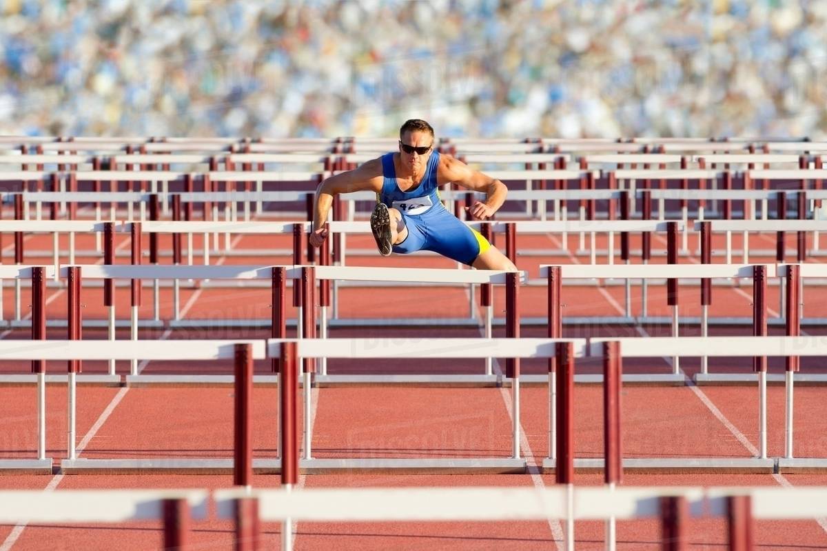 Male hurdler clearing hurdles - Royalty-free Stock Photo | Dissolve