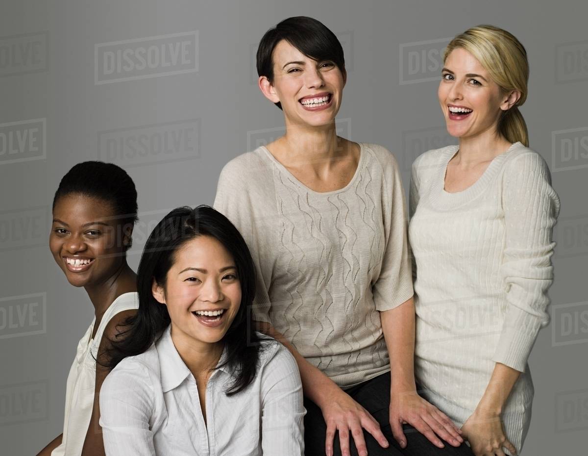Four women laughing - Royalty-free Stock Photo | Dissolve