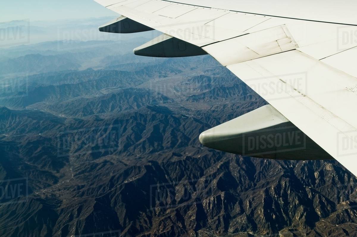 Airplane over mountains in china - Stock Photo - Dissolve