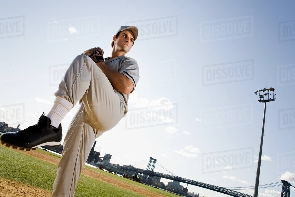 Baseball pitcher standing on one leg - Royalty-free Stock Photo | Dissolve
