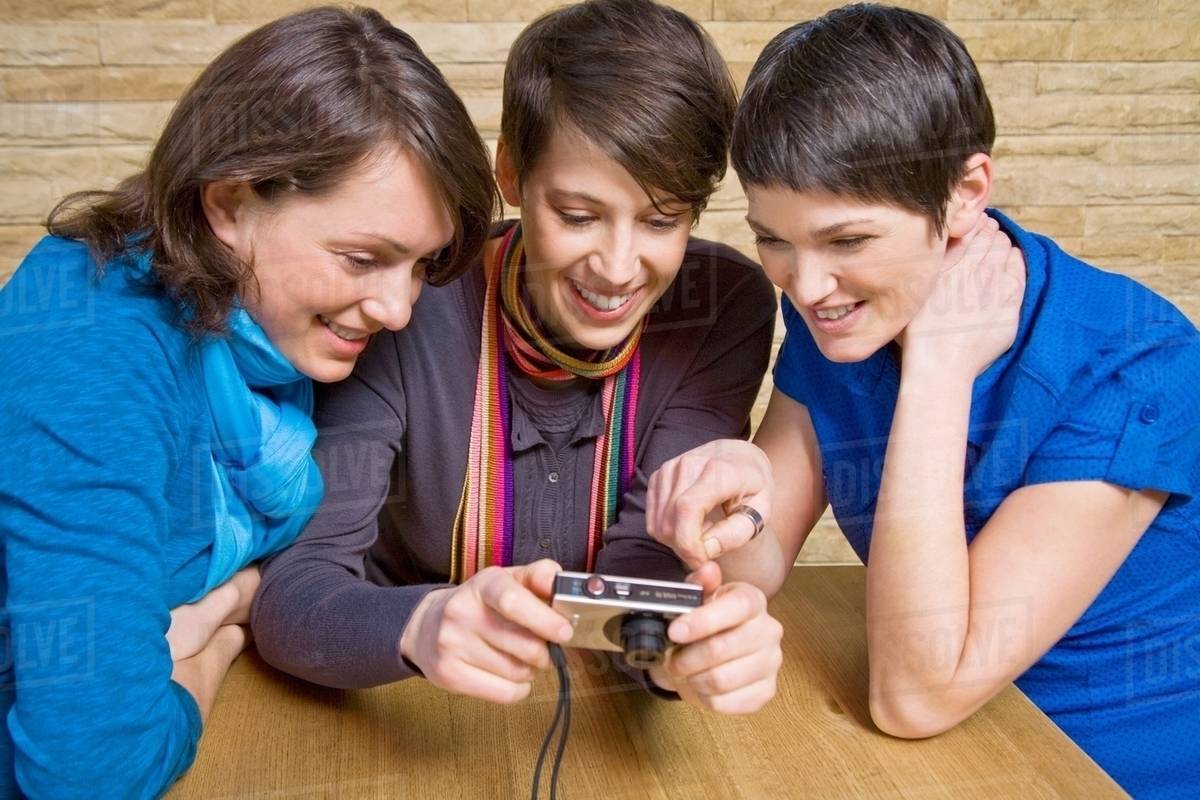 Friends looking at a camera - Stock Photo - Dissolve