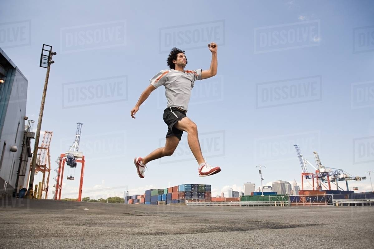 Man athlete jumping - Stock Photo - Dissolve