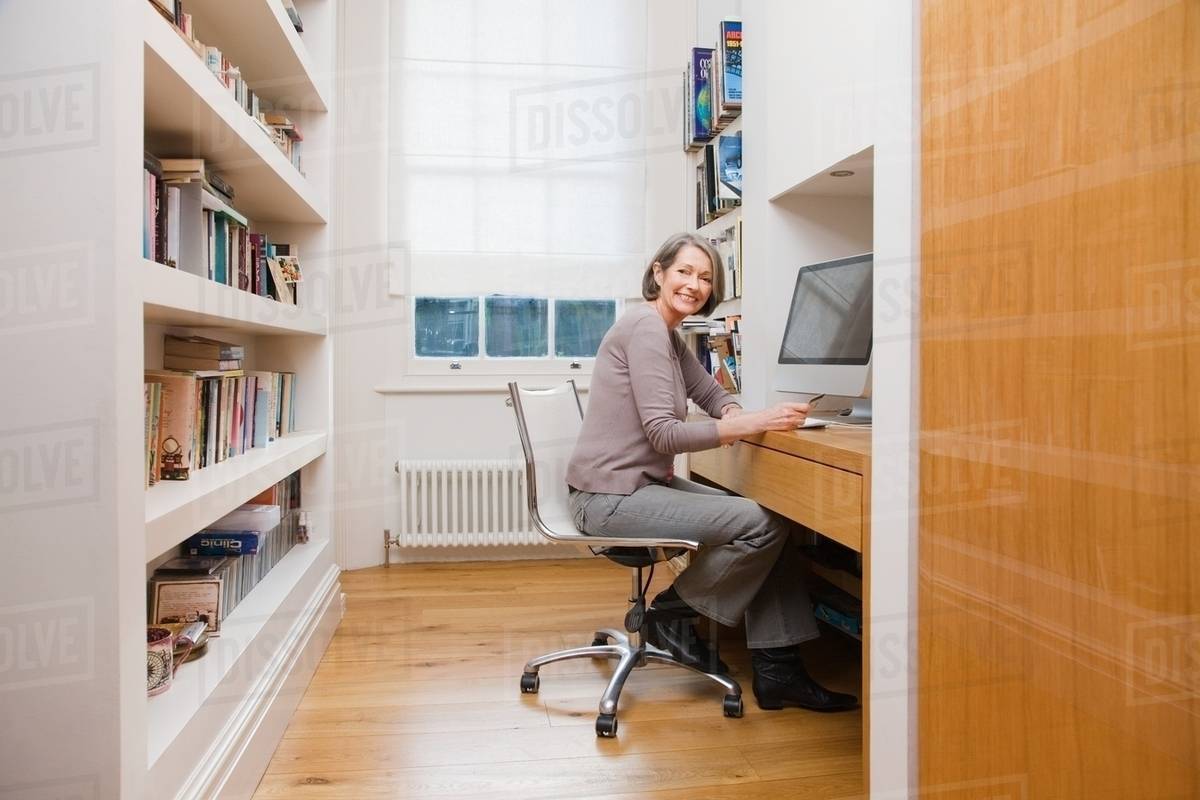Mature woman using a computer - Royalty-free Stock Photo | Dissolve