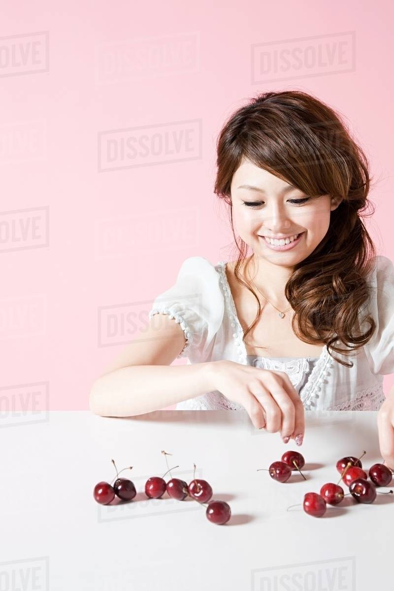 Woman with cherries - Royalty-free Stock Photo | Dissolve