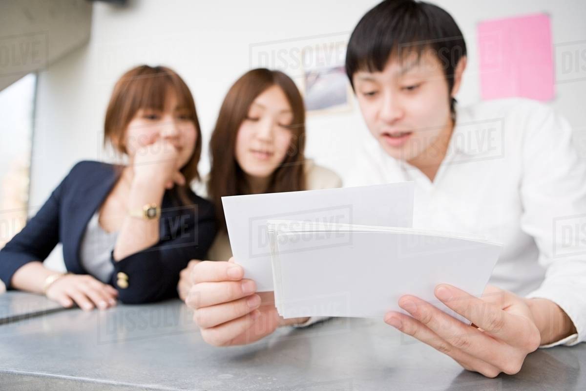 People looking photographs - Royalty-free Stock Photo | Dissolve