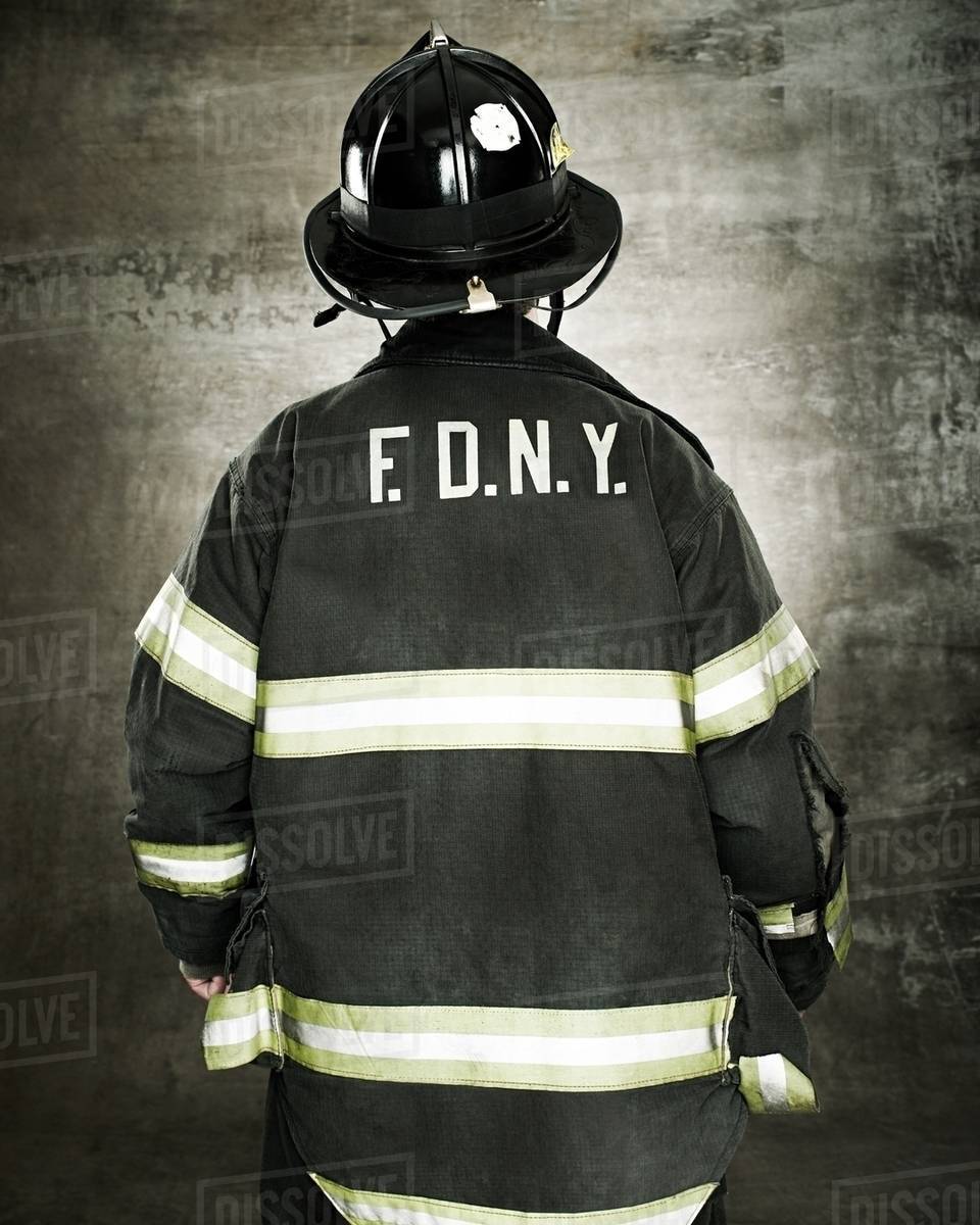 Rear view of a firefighter - Stock Photo - Dissolve