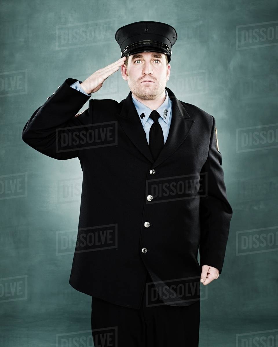 Portrait of a firefighter saluting - Royalty-free Stock Photo | Dissolve